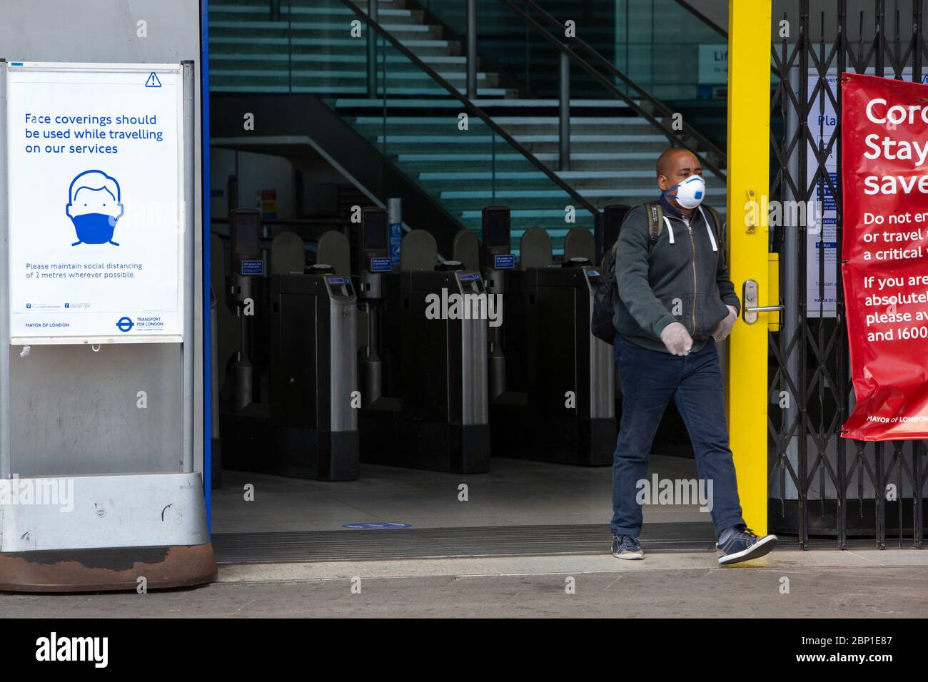 May 2020: Essential workers walk past public health information posters ...