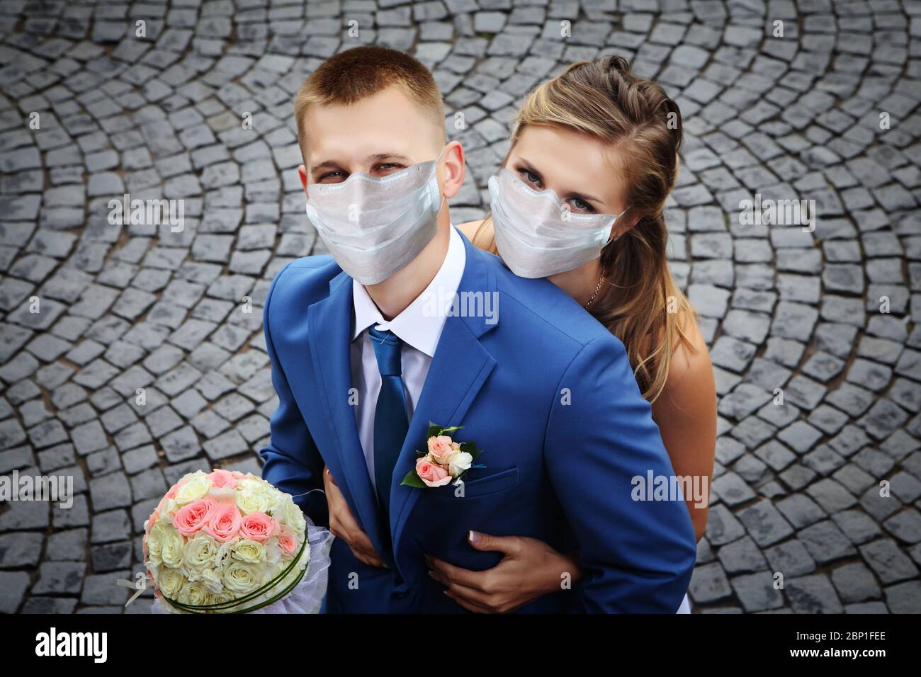 Couple of newlyweds walks in medical facial disposable masks for ...