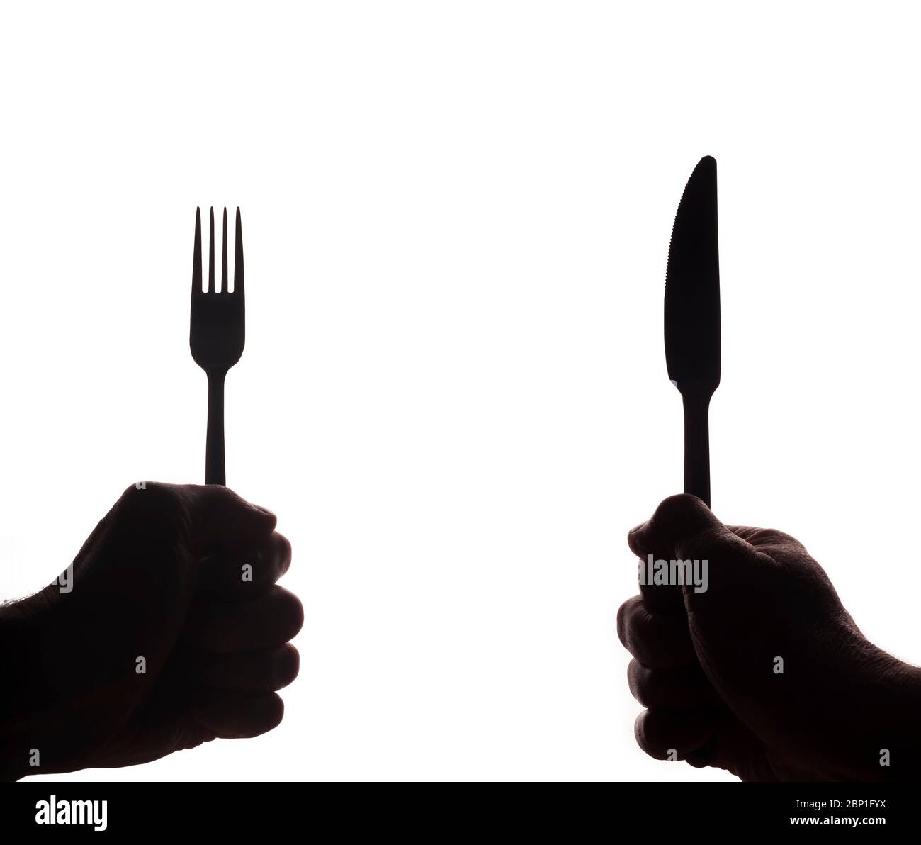 Hands holding a knife and fork on a white backlit background Stock ...