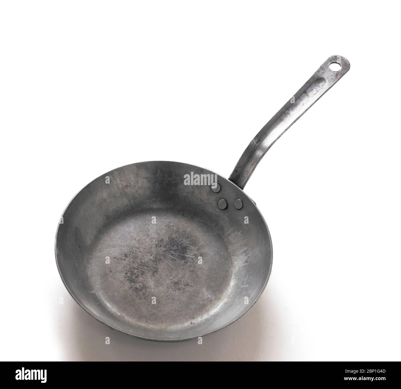Empty cast iron frying pan on white background Stock Photo - Alamy