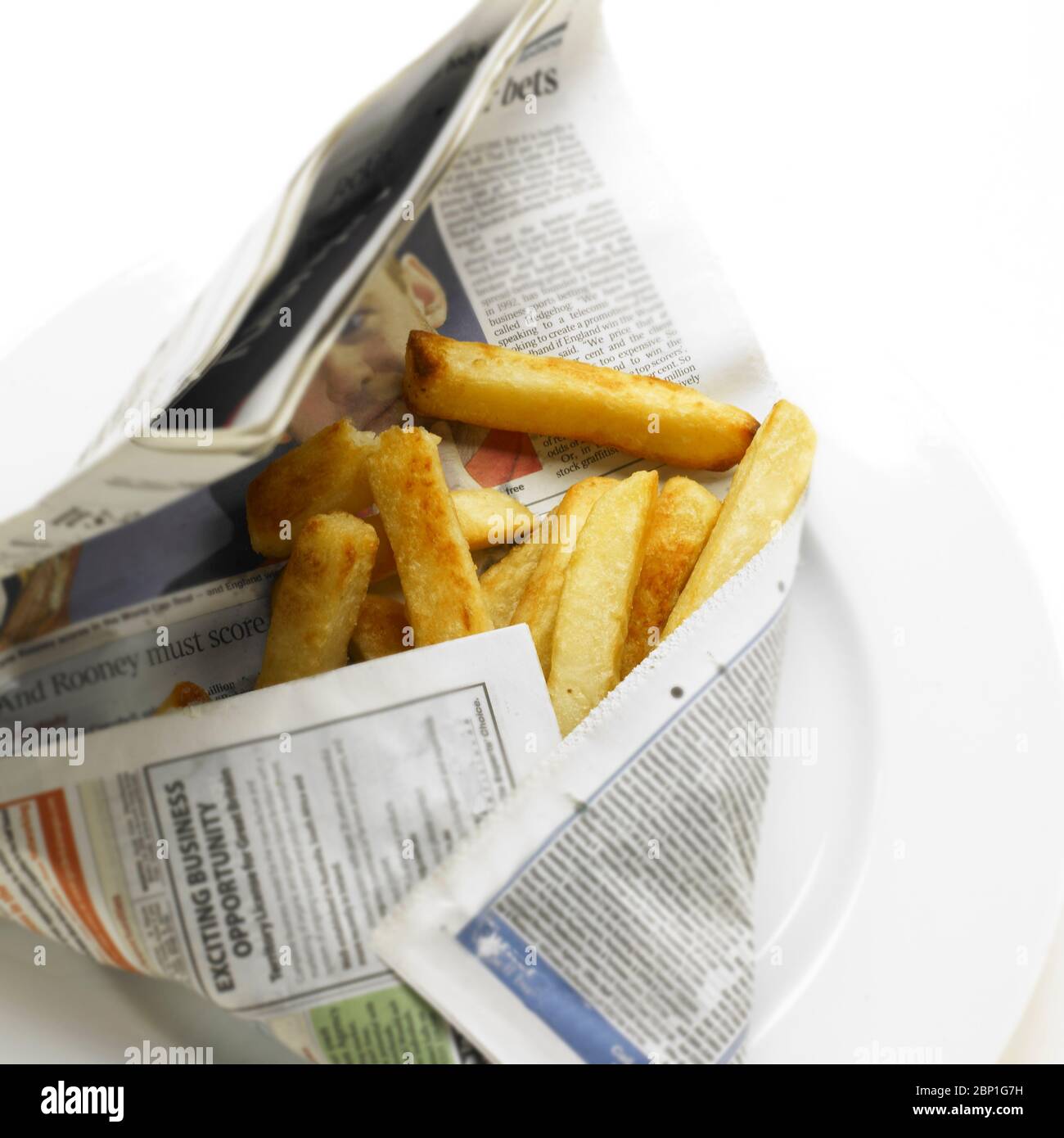 Chips wrapped in a newspaper Stock Photo - Alamy