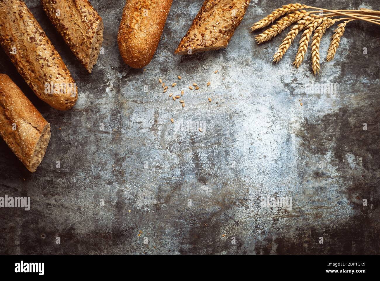 Fresh bakery food. Crusty loaves of mixed breads and buns and ears of ...