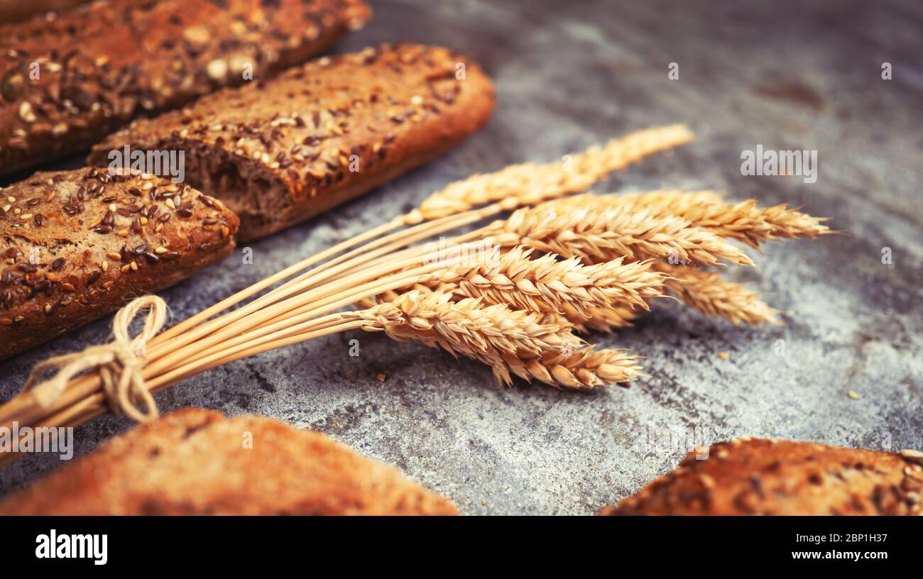 Fresh bakery food. Crusty loaves of mixed breads and buns and ears of ...