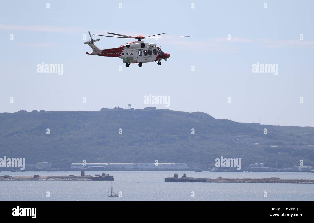 An AgustaWestland AW189 helicopter from HM Coastguard flies over ...
