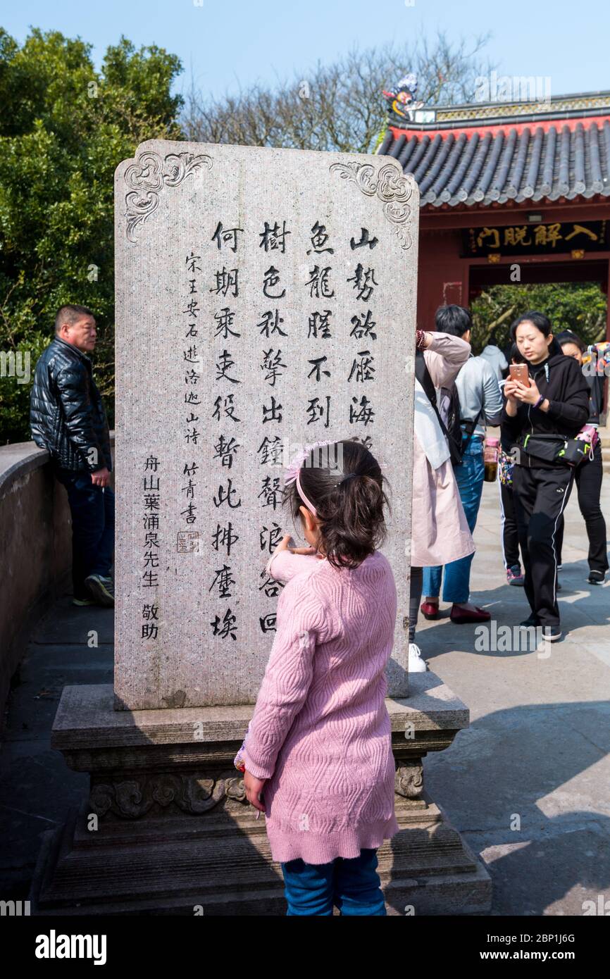 A Chinese girl touching the calligraphy on stone by famous person in ...
