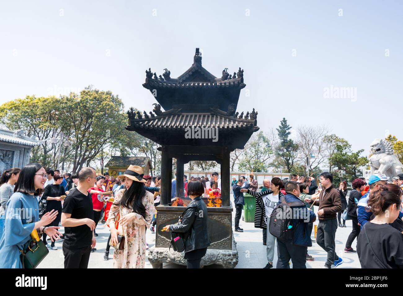 Pilgrim burning incense and praying at Mount Luojia, which lies in the ...