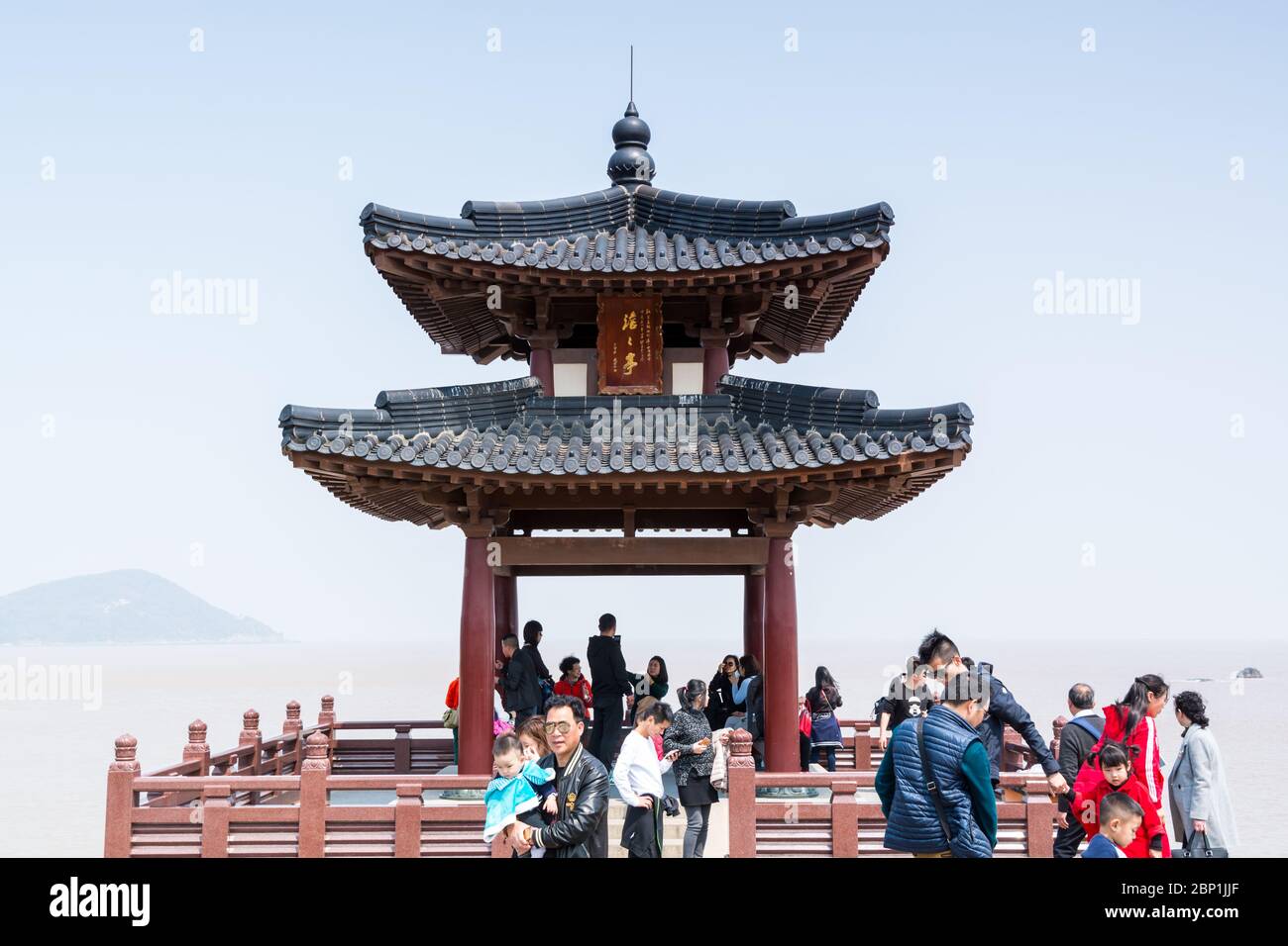 Tourists at the pavilion in Mount Luojia, which lies in the Lotus Sea ...