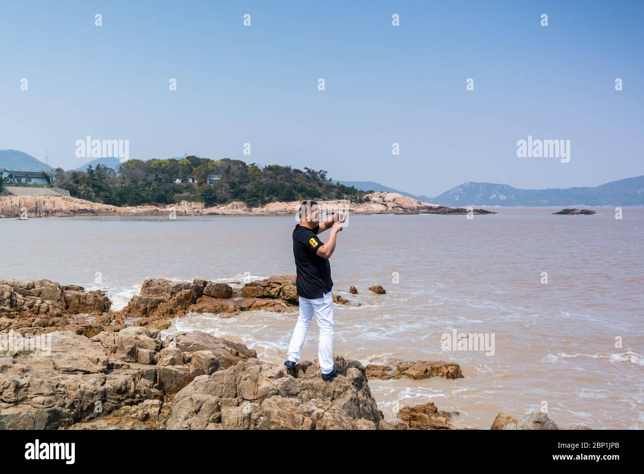 Tourist at the seaside at Mount Luojia, which lies in the Lotus Sea to ...
