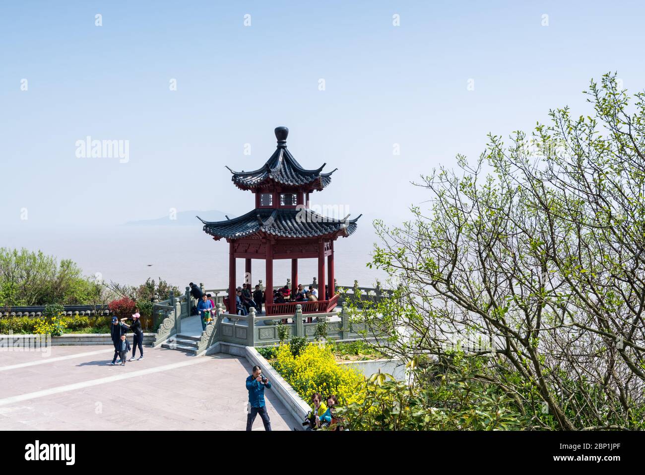 Tourists at the pavilion in Mount Luojia, which lies in the Lotus Sea ...
