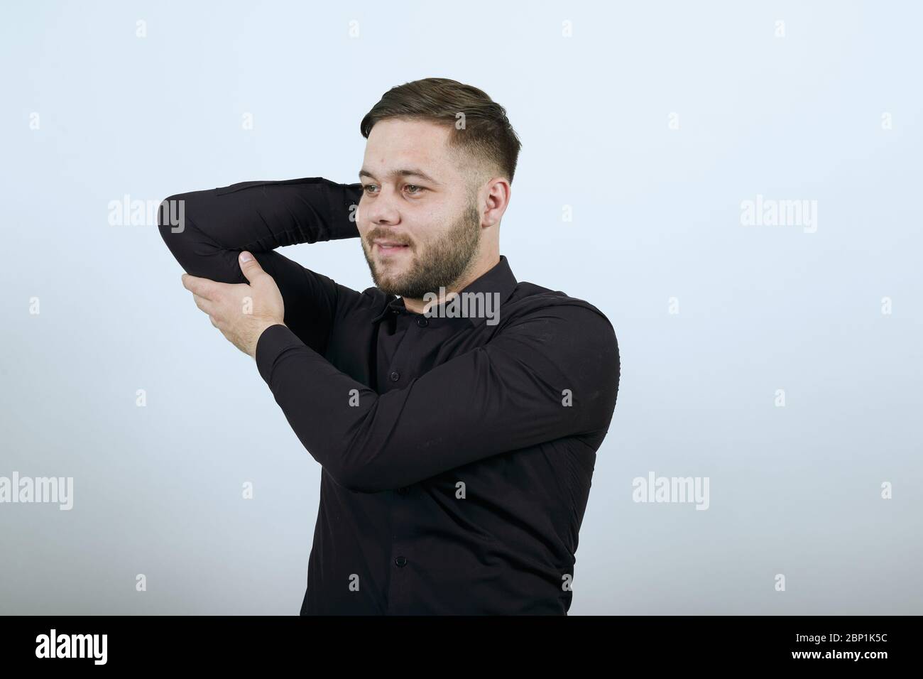 Confident Male Raised His Elbow And Poses For The Camera Stock Photo ...