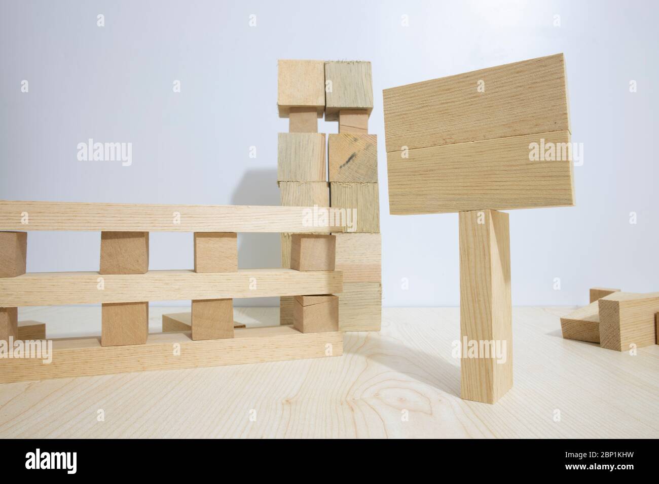 Building from wooden cubes and rods. The photo was taken on the white ...