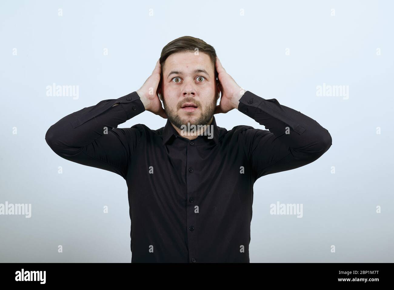 Shocked Male Holds Hands Over His Head And Emotionally Made Big Eyes ...