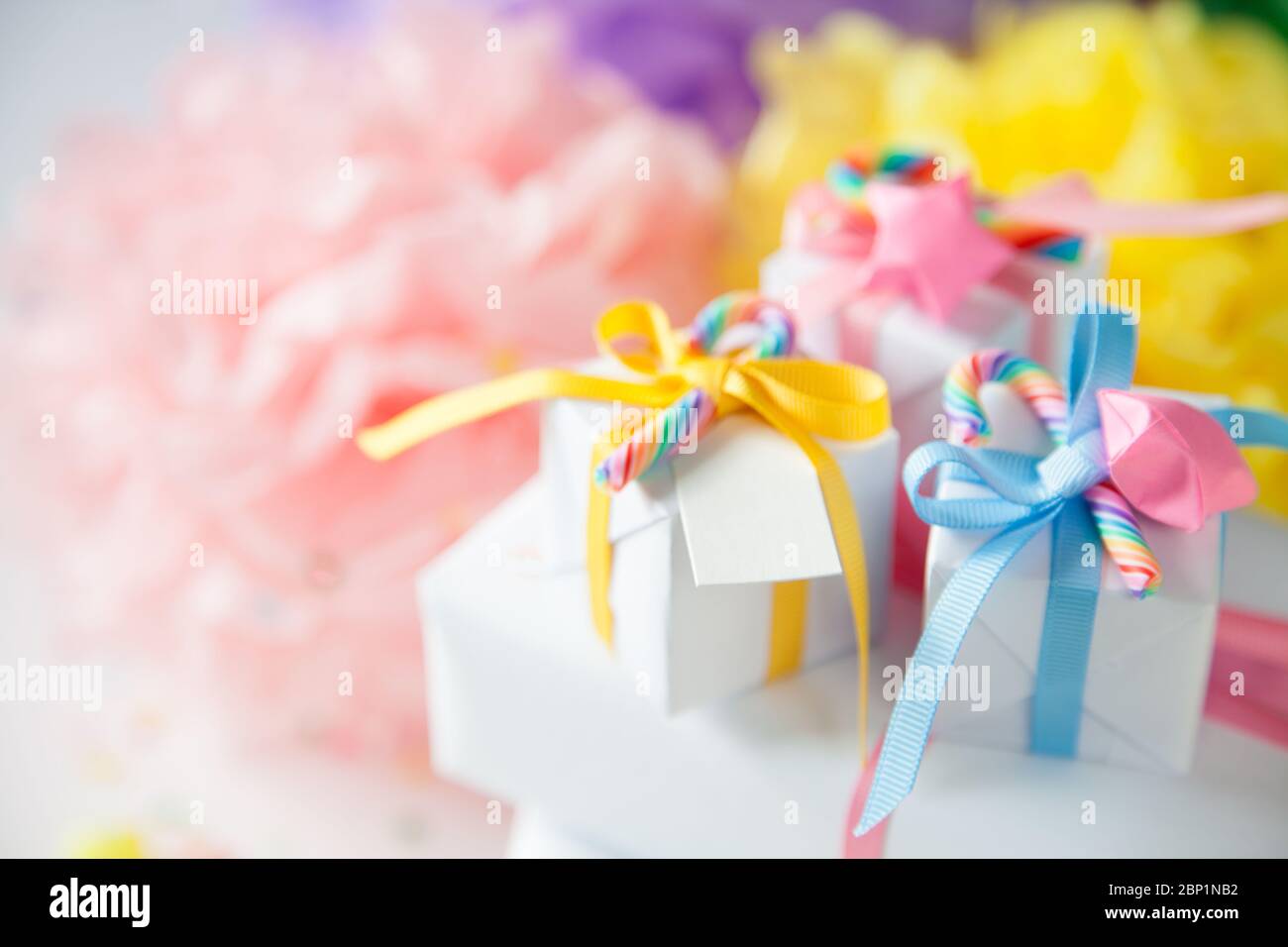 Colored small gift boxes with colorful ribbons Stock Photo - Alamy