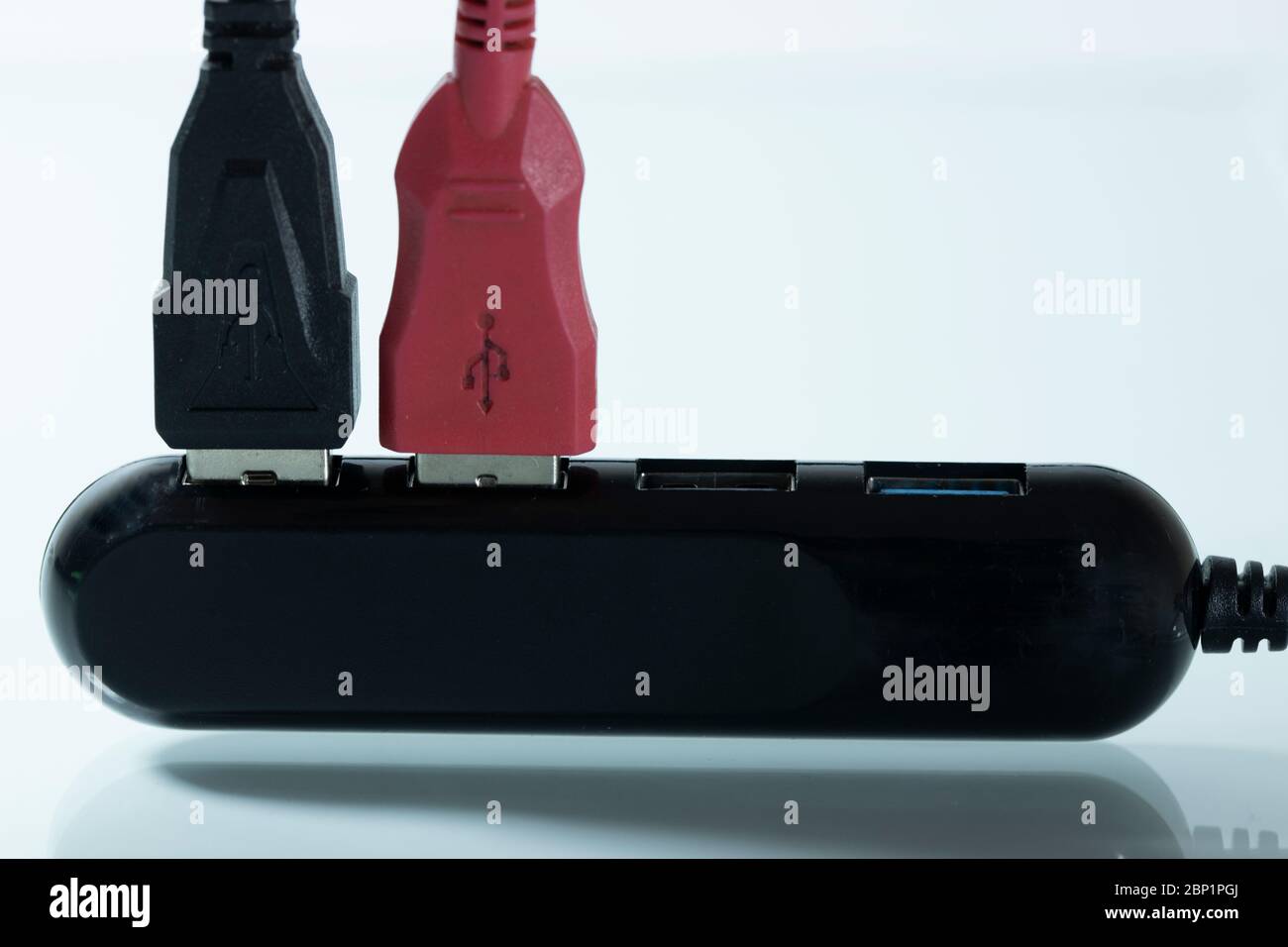 USB multiplexer close-up on white background. It has two usb attached ...