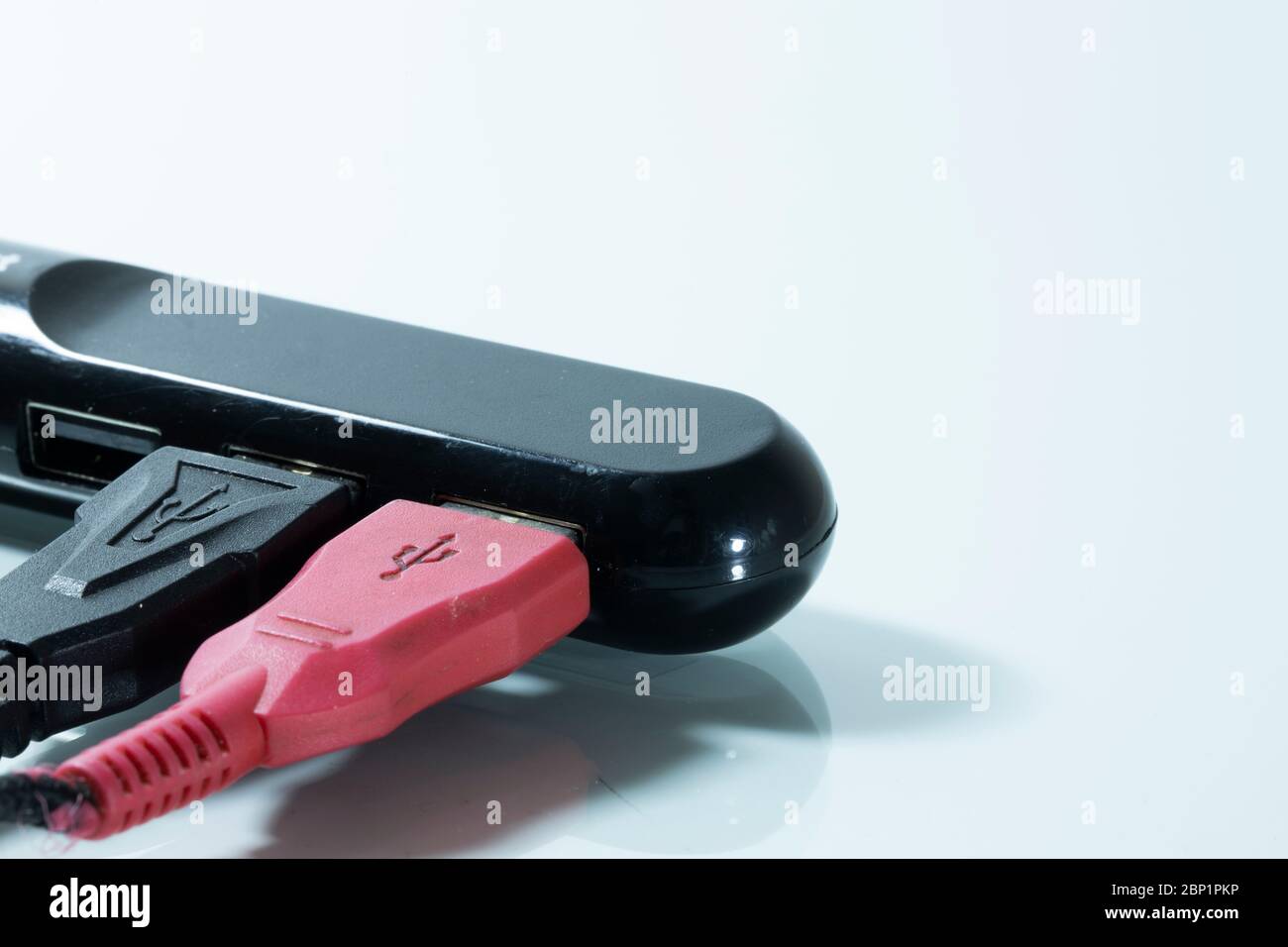 USB multiplexer close-up on white background. It has two usb attached ...