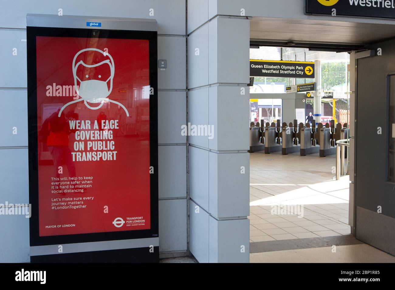 May 2020: Essential workers walk past public health information posters ...