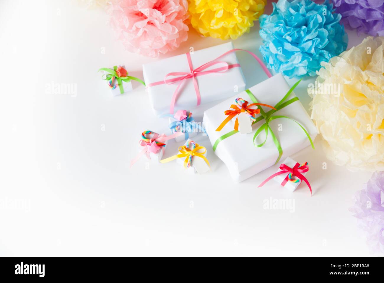 Colored small gift boxes with colorful ribbons Stock Photo - Alamy