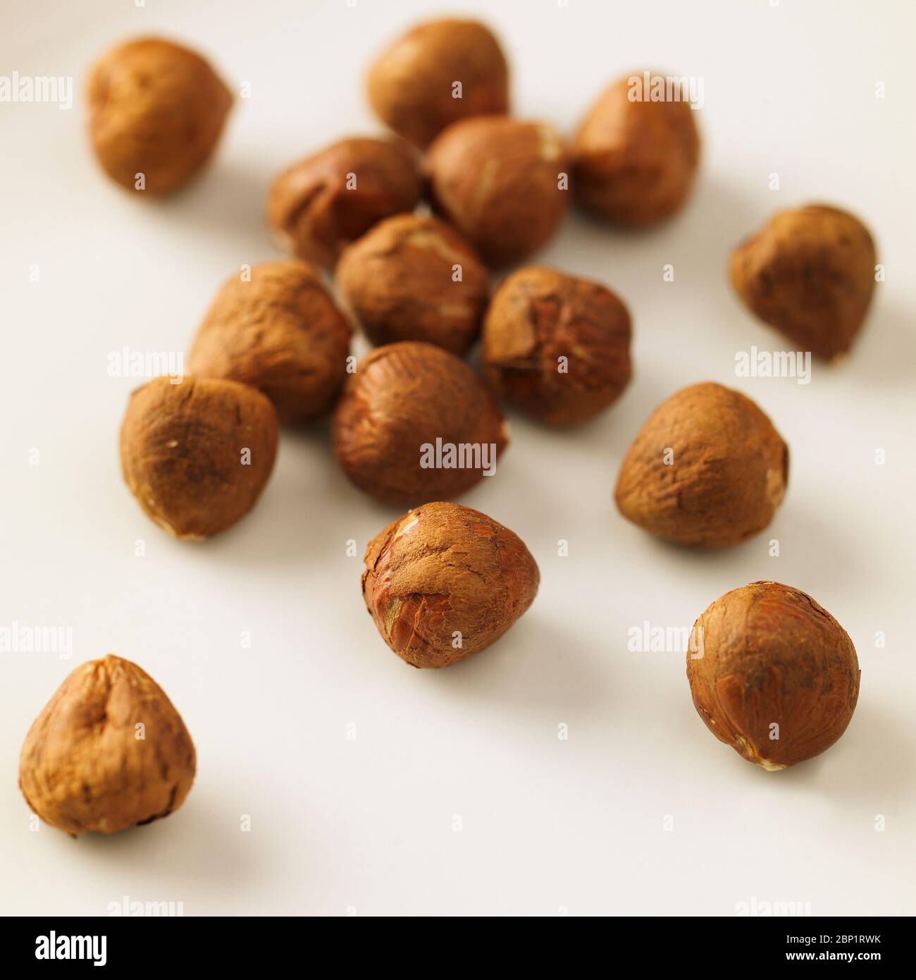 Shelled Hazelnuts on a white background Stock Photo - Alamy