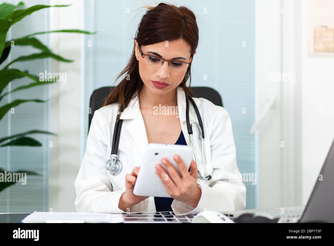 Beautiful female doctor in her studio Stock Photo - Alamy
