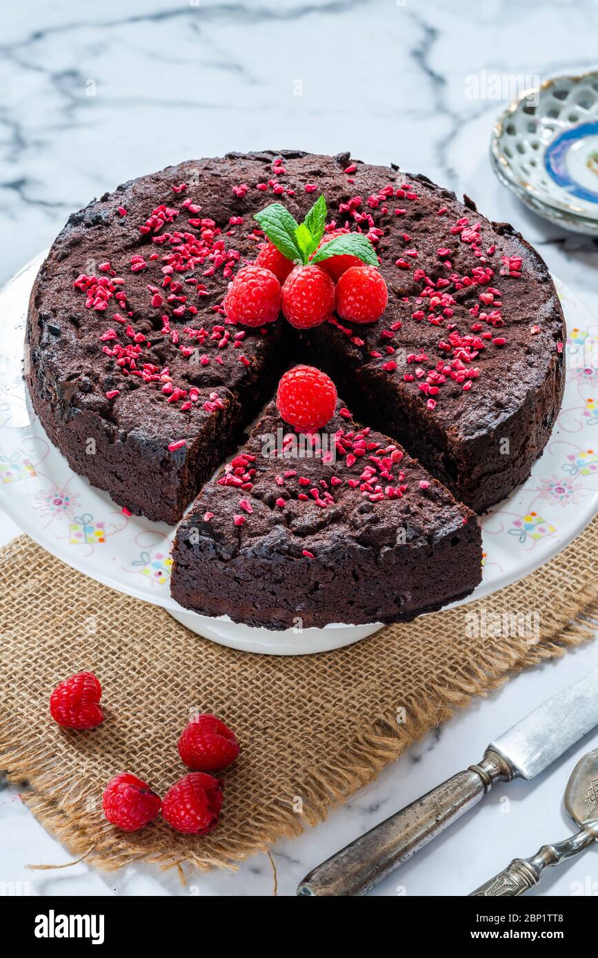 Chocolate and raspberry torte garnished with fresh fruit and mint Stock ...