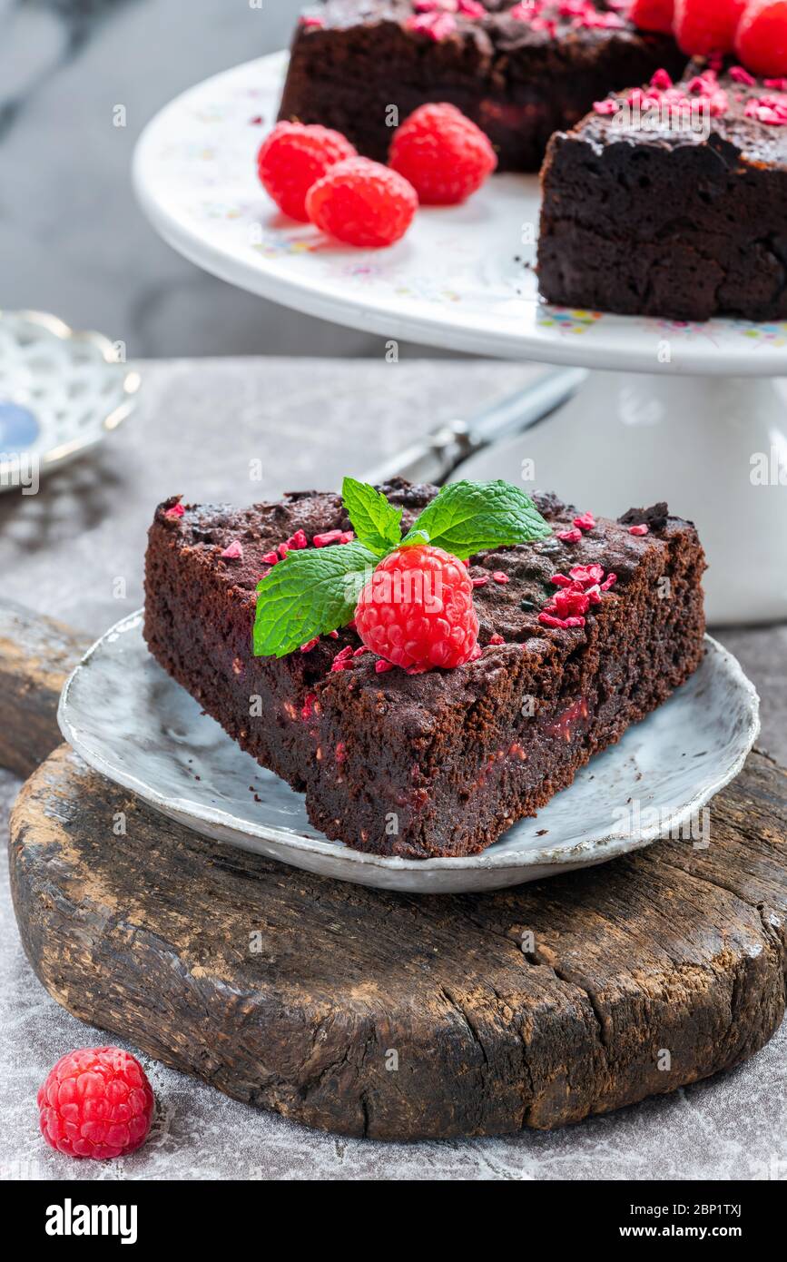 Chocolate and raspberry torte garnished with fresh fruit and mint Stock ...