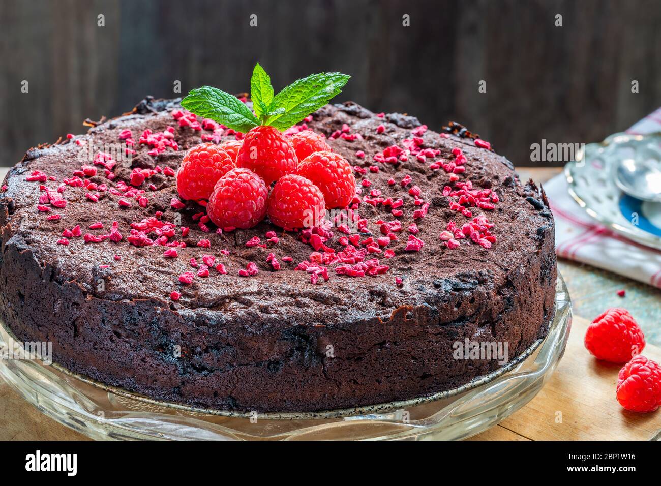 Chocolate and raspberry torte garnished with fresh fruit and mint Stock ...