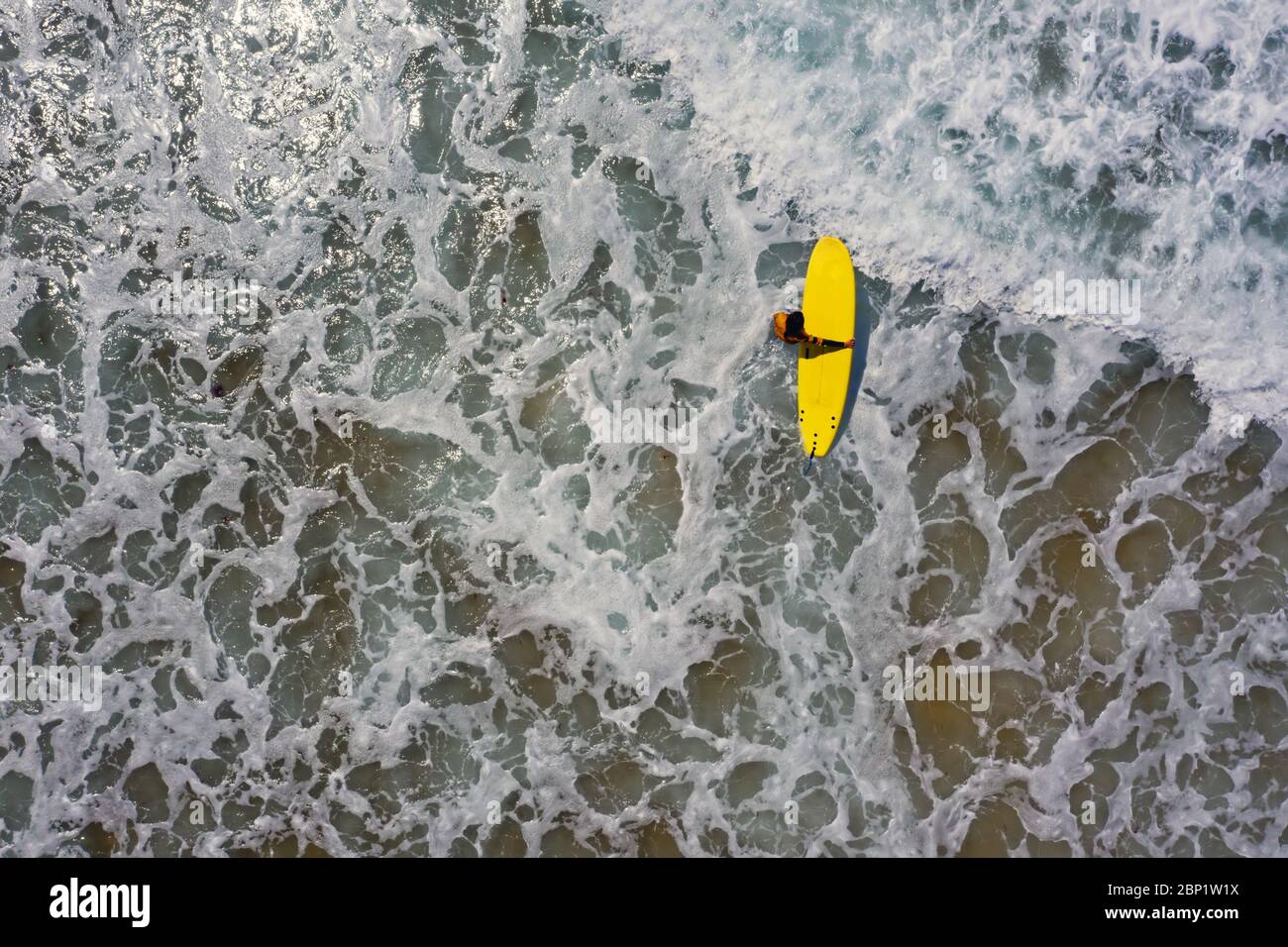 Aerial shot from a surfer going to surf in the ocean Stock Photo - Alamy