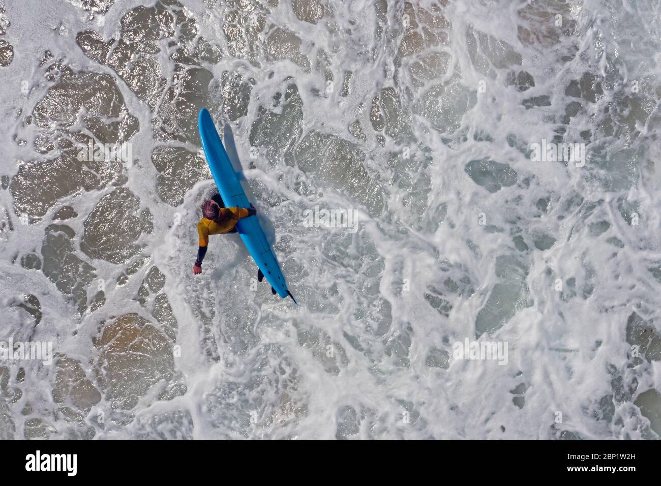 Aerial from a surfer going to surf in the atlantic ocean Stock Photo ...