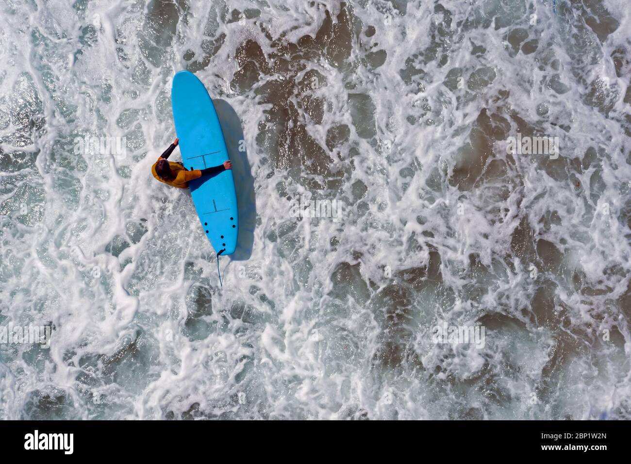 Aerial shot from a surfer going to surf in the ocean Stock Photo - Alamy
