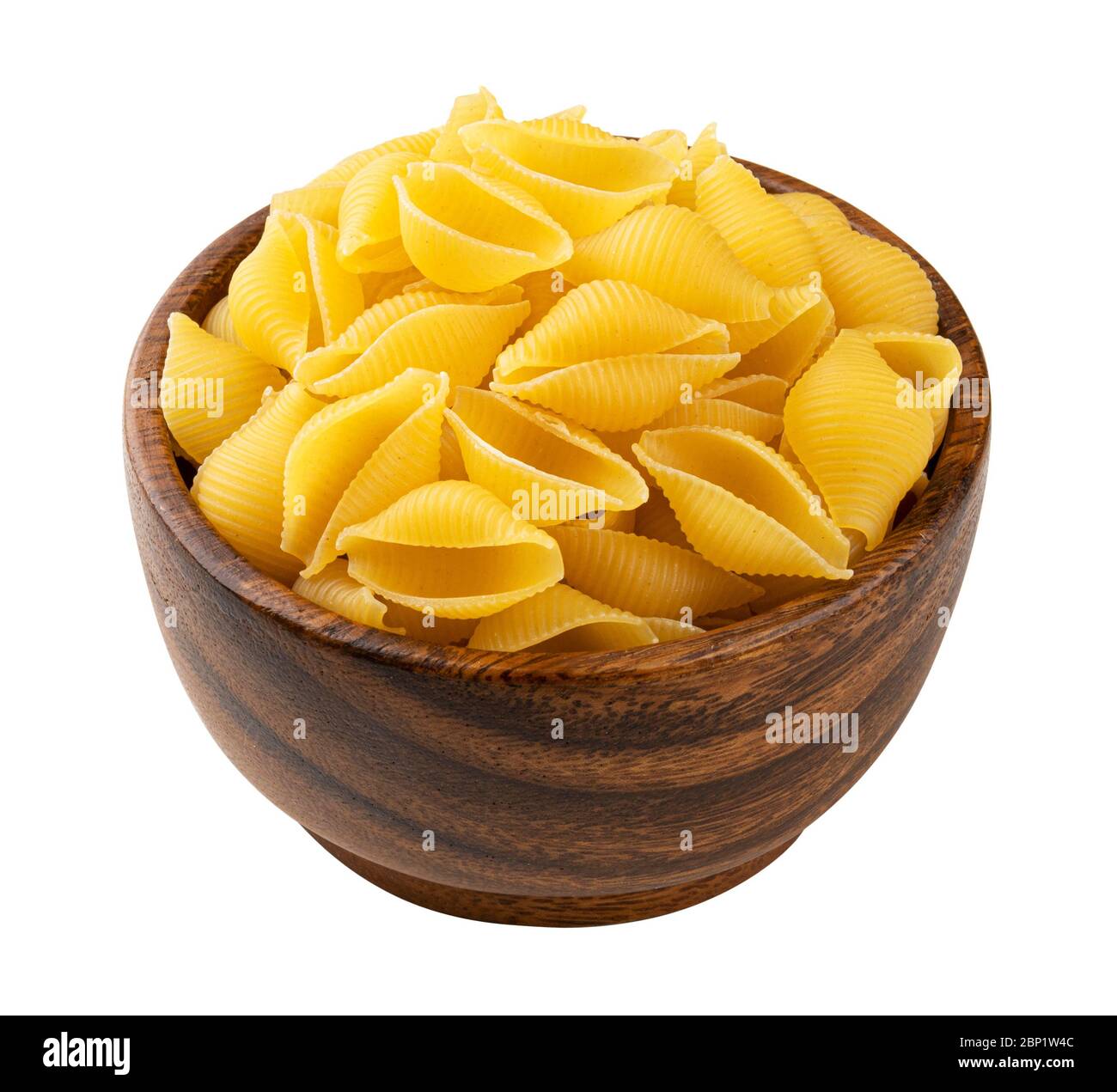 Conchiglie rigate pasta in wooden bowl isolated on white background ...