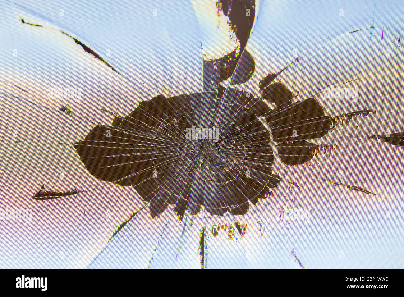 close-up view of physically damaged lcd screen surface with impact spot ...