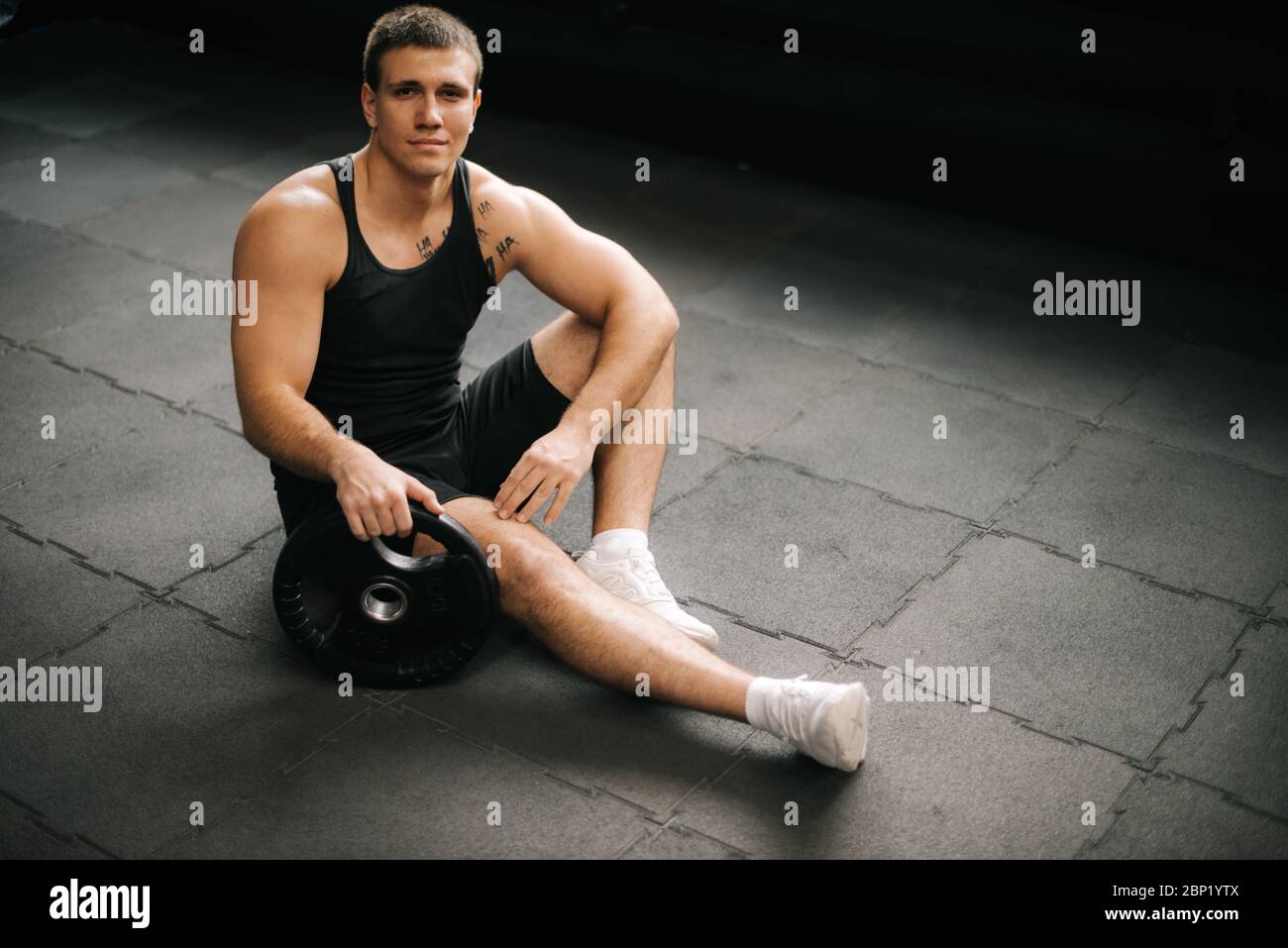 Muscular man sitting on floor hi-res stock photography and images - Alamy