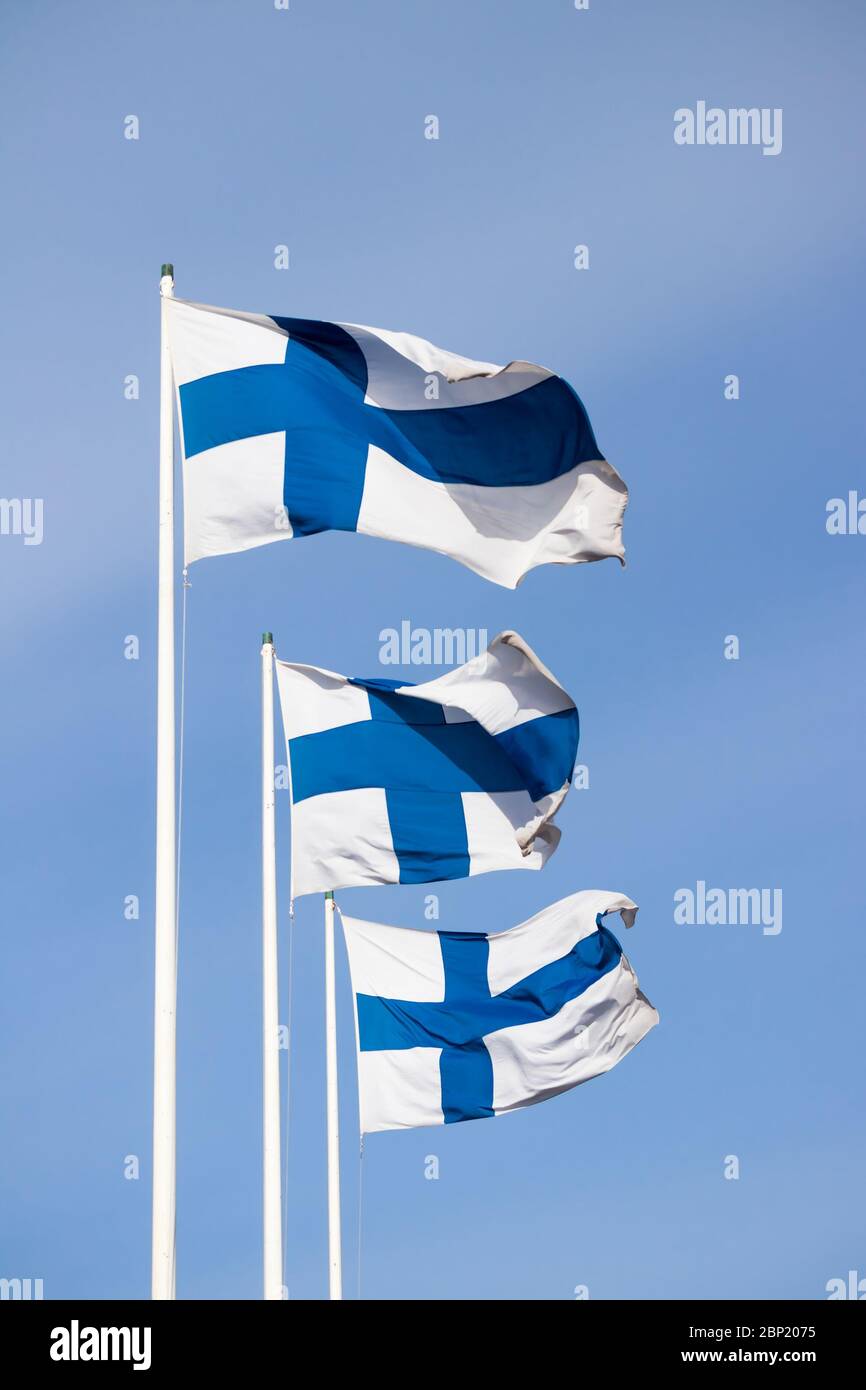 Three finnish national flags on the wind against the blue sky Stock ...