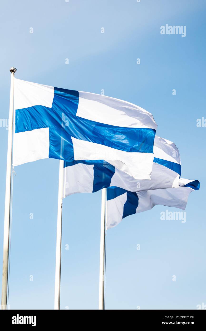 Three finnish national flags on the wind against the blue sky Stock ...