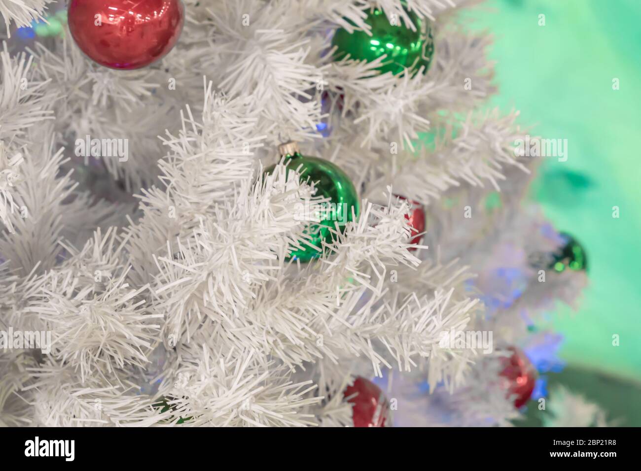beautiful white christmas tree with green and red balls Stock Photo - Alamy
