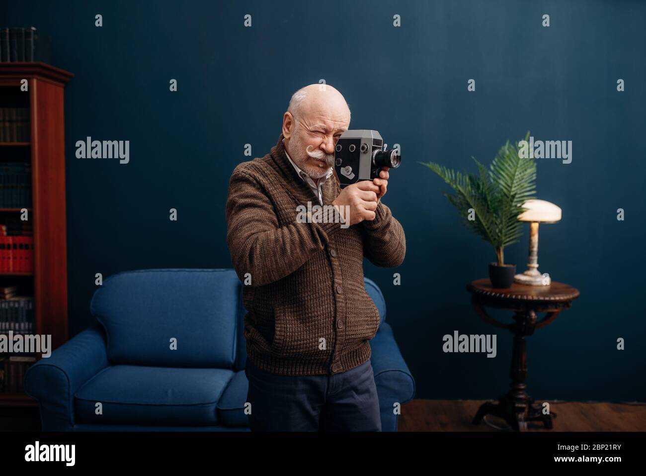 Elderly man poses with old film camera Stock Photo - Alamy