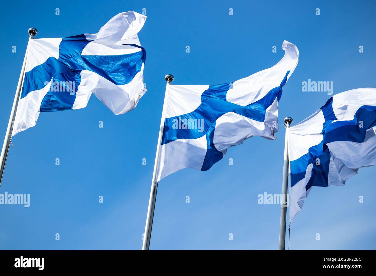 Three finnish national flags on the wind against the blue sky Stock ...