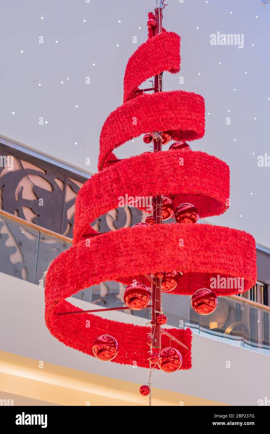 red xmas tree and garland hanging on ceiling closeup Stock Photo - Alamy