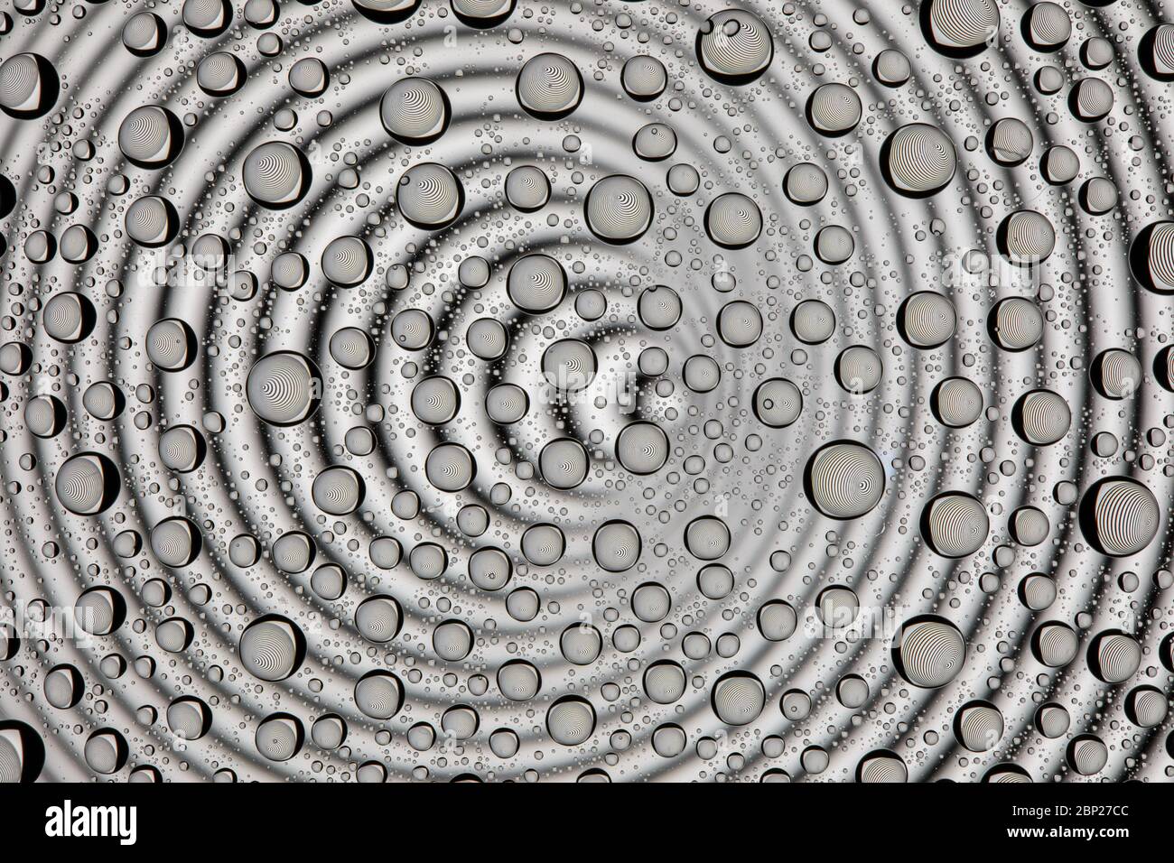 Concentric black and white lines through drops of water on glass Stock ...