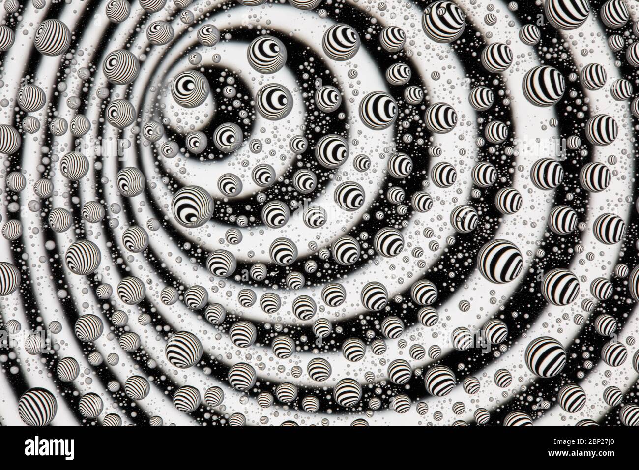 Concentric black and white lines through drops of water on glass Stock ...
