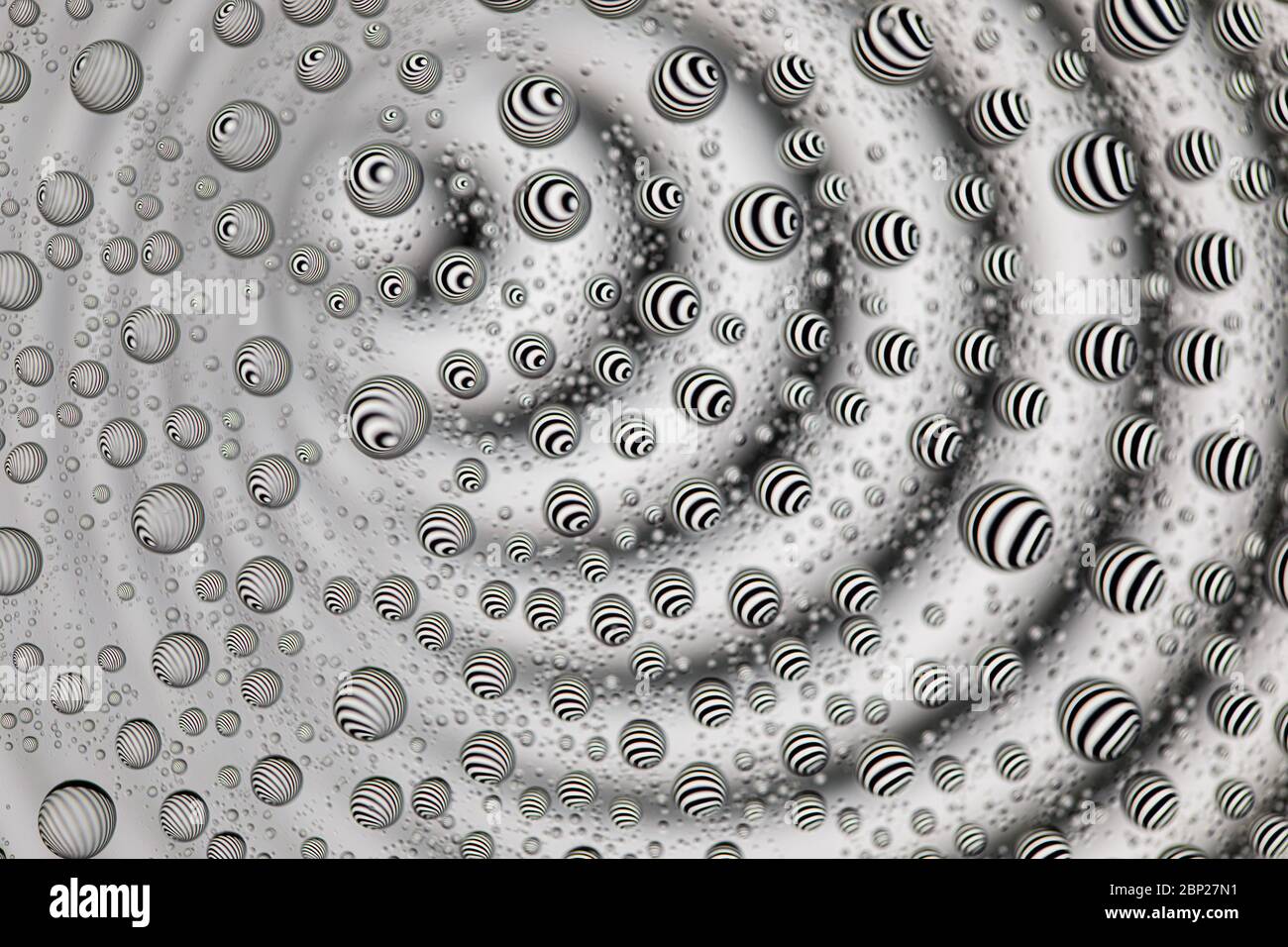 Concentric black and white lines through drops of water on glass Stock ...
