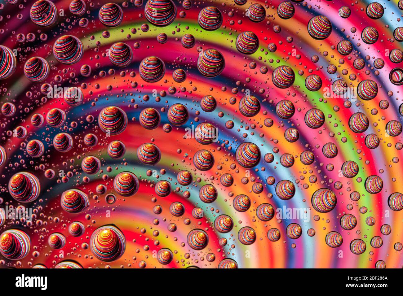 Concentric multicolored lines through drops of water on glass Stock ...