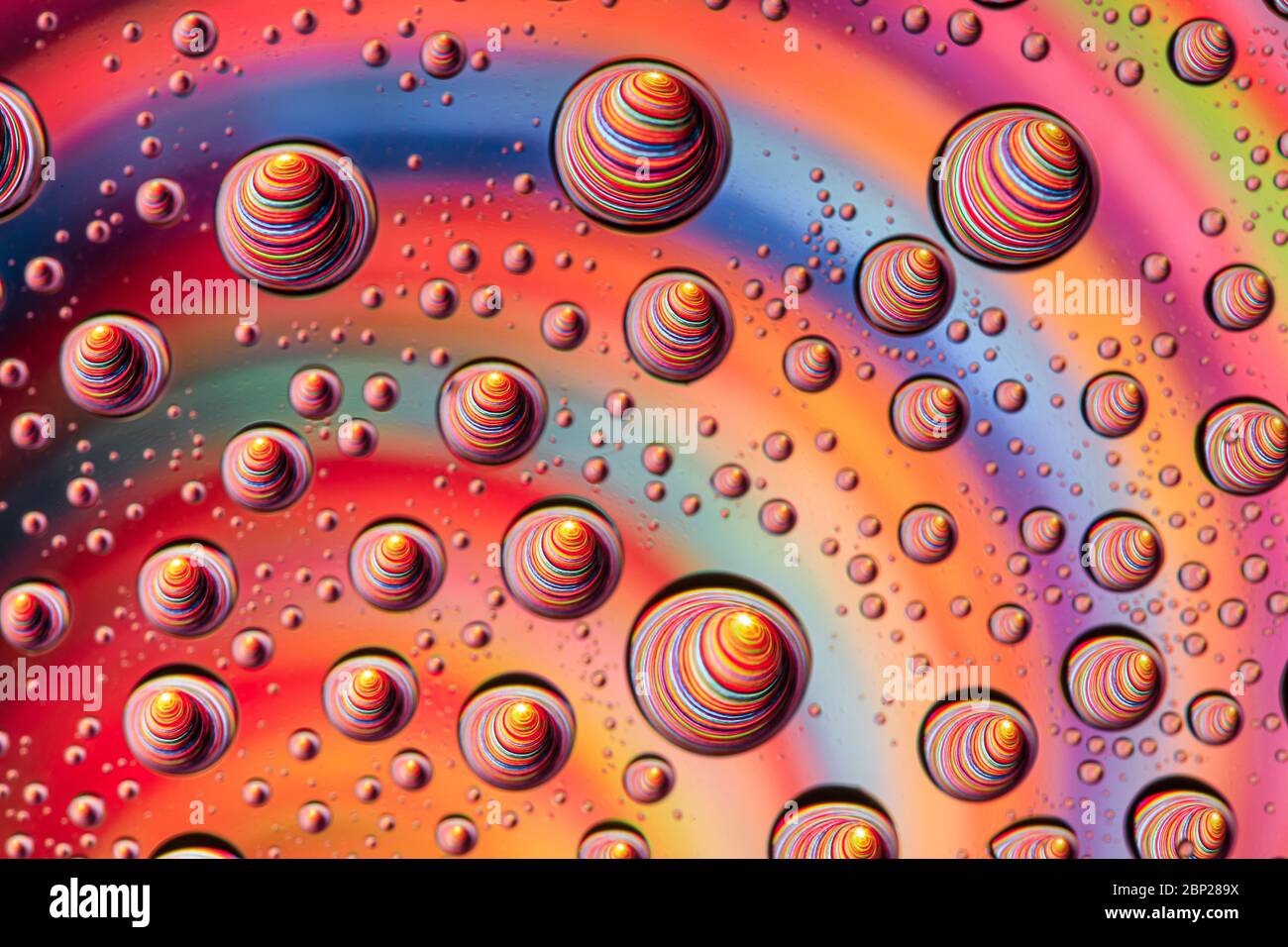 Concentric multicolored lines through drops of water on glass Stock ...