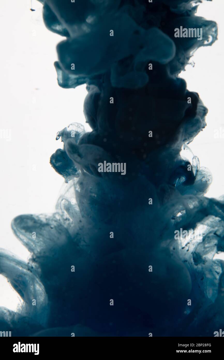 a beautiful image of a colorful light blue liquid mixing in water ...