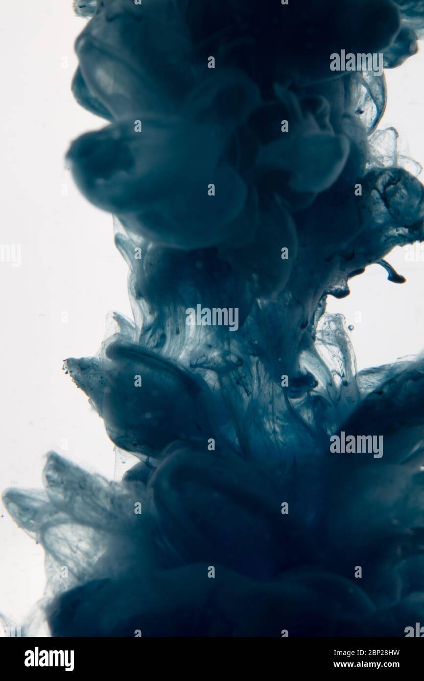 a beautiful image of a colorful light blue liquid mixing in water ...