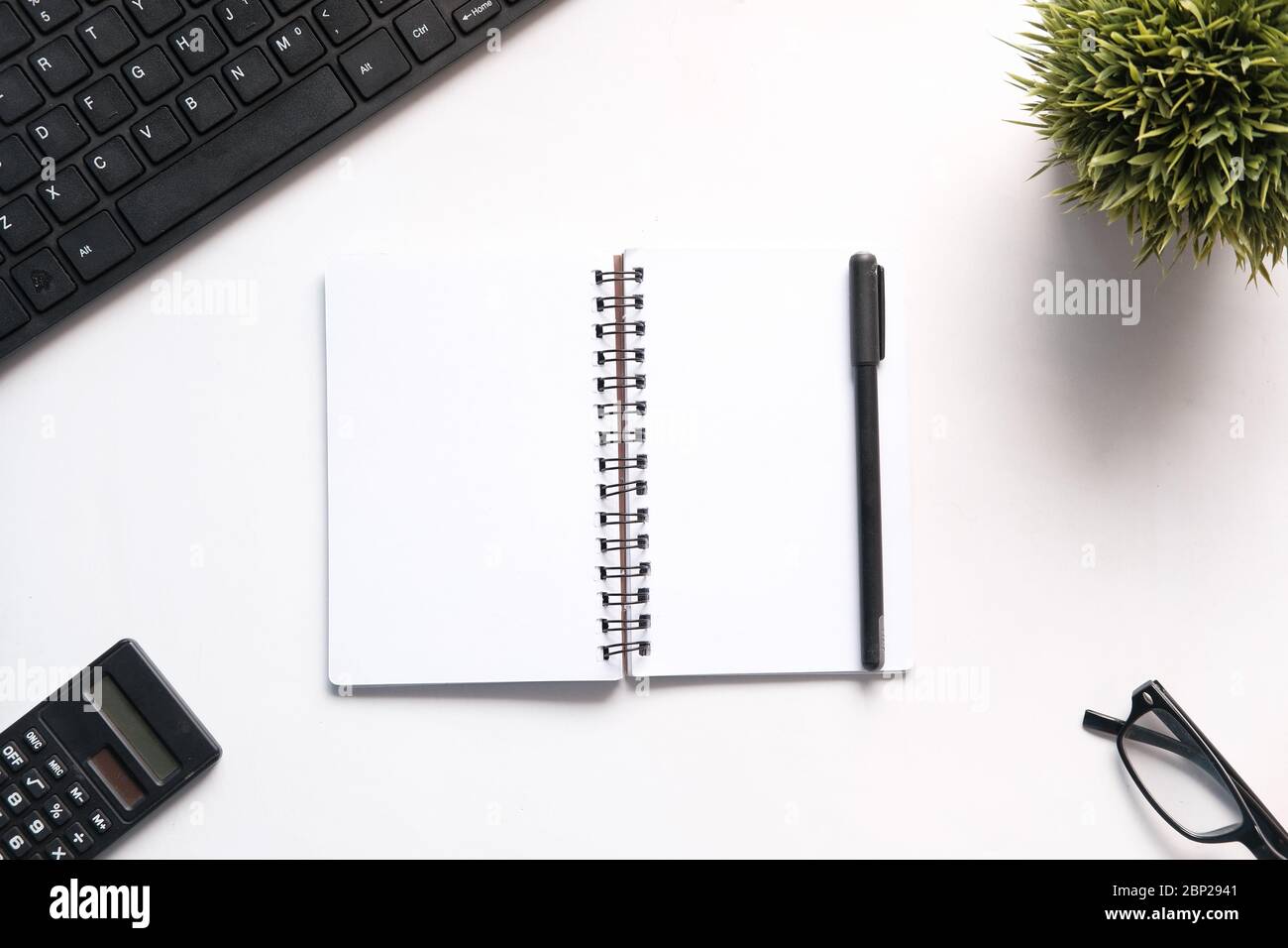 Top view of notepad , keyboard and a pen on white background Stock ...