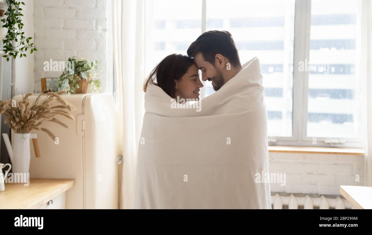 Couple Cuddling In Blankets