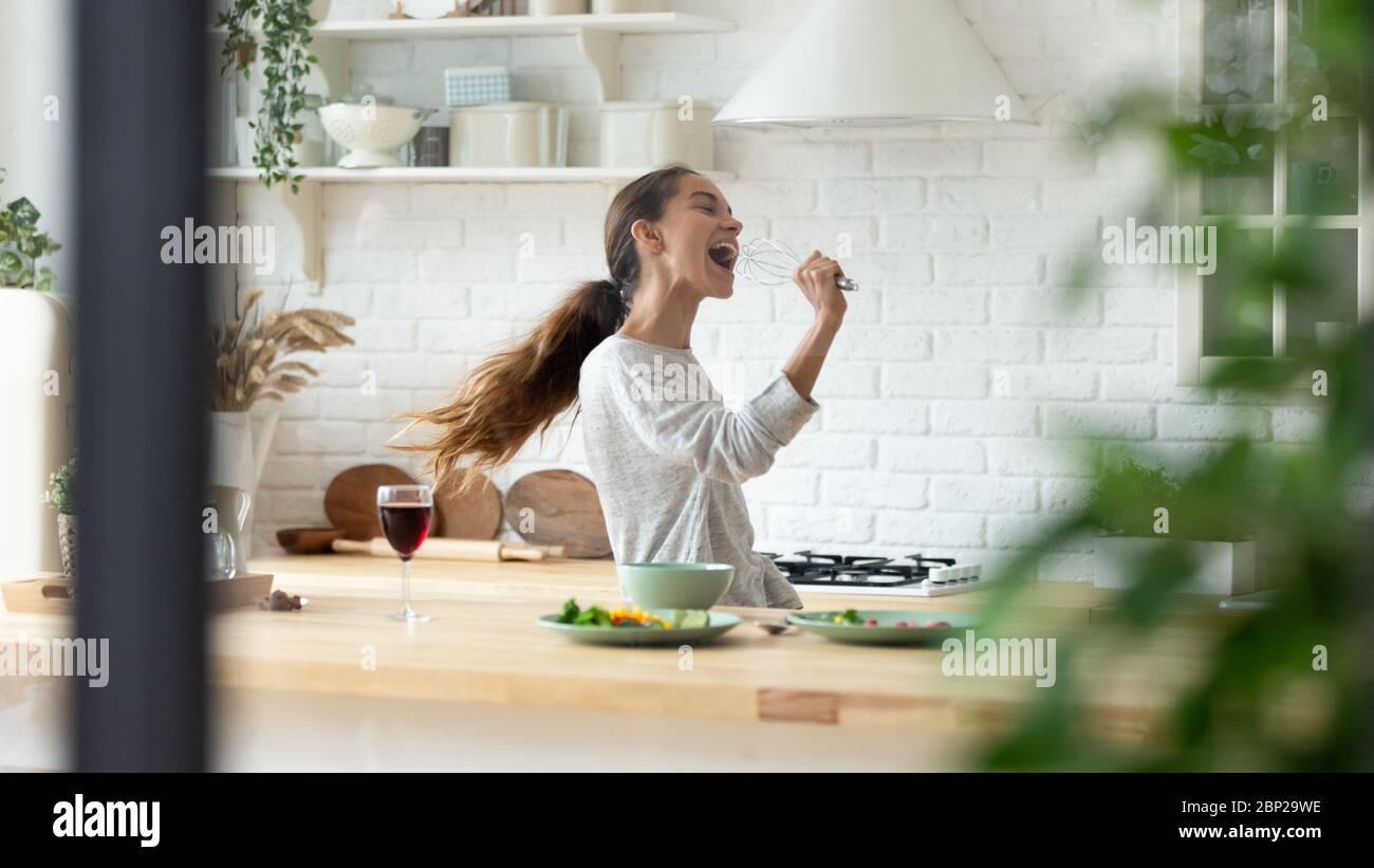 Happy girl have fun dancing cooking at home Stock Photo - Alamy