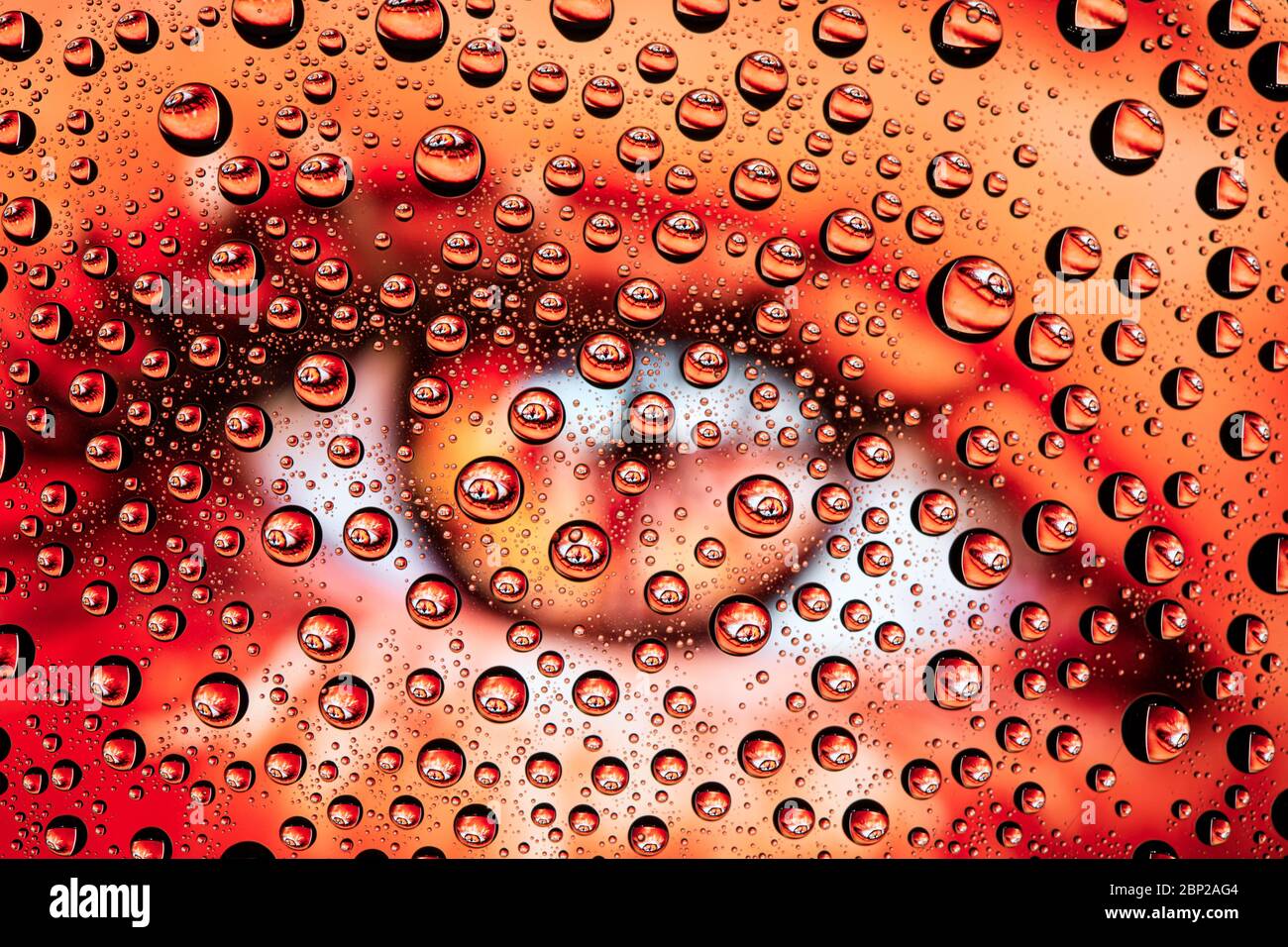 Female eye through drops of water on glass Stock Photo - Alamy