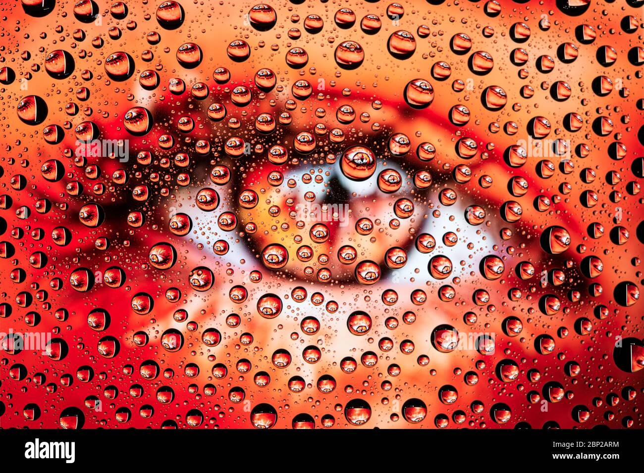 Female eye through drops of water on glass Stock Photo - Alamy